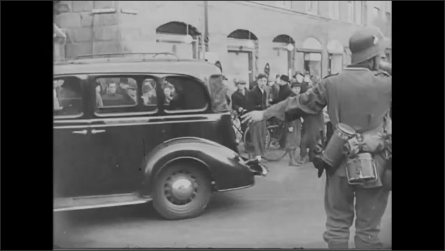 1940s: Crowd cheers as soldiers drive through town. Soldiers shake ...