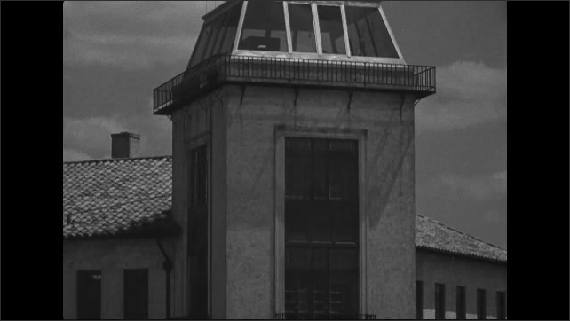 1940s: Airfield control tower. An airplane stops its prop spinning ...