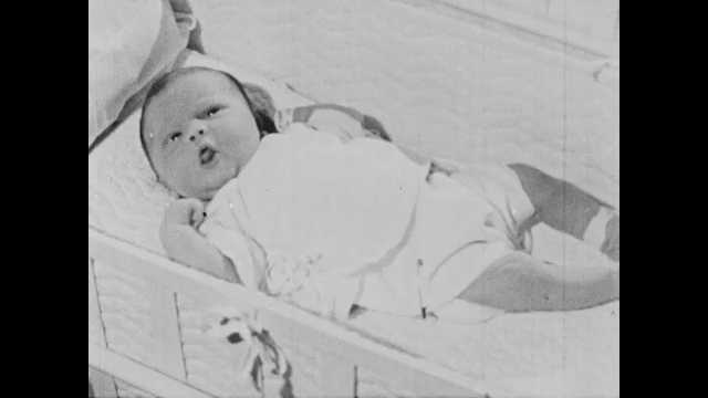 1950s: Baby lays in isolette and wiggles and cries. – Archival Footage
