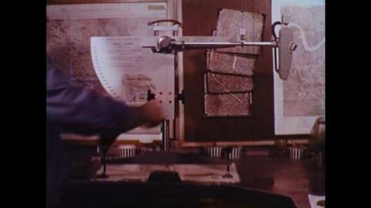 UNITED STATES: 1970s: pendulum device tests surface friction. Man looks ...