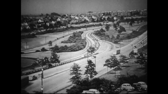 UNITED STATES 1950s : Extreme long-shot of cars driving down suburban ...