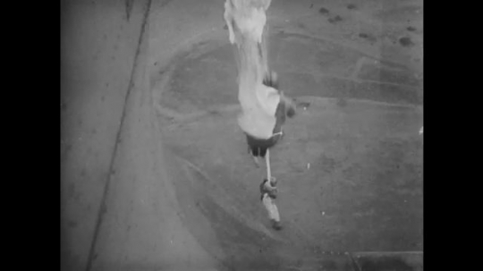 UNITED STATES 1940s: Aerial view, paratroopers jump from plane ...