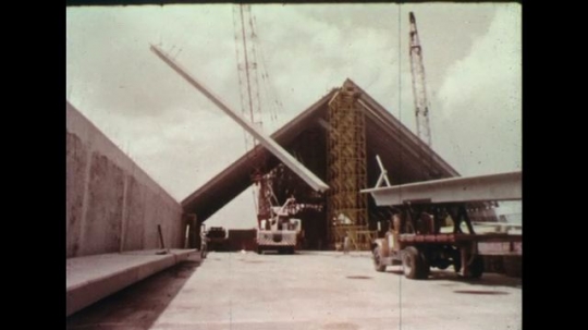 UNITED STATES 1960s:Cranes on construction site / Crane lifts metal ...