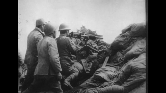 UNITED STATES 1940s: Soldier fires machine gun / Soldiers watch trucks ...