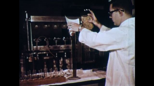 UNITED STATES 1960s: Man in lab, pours cereal into tube / Man pours ...