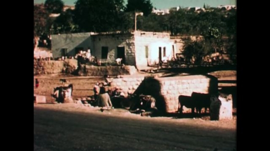 NAZARETH, ISRAEL: 1960s: Lady carries container on her head in village ...