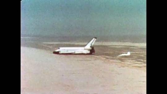 UNITED STATES: 1981: Space shuttle flies over desert escorted by jet ...