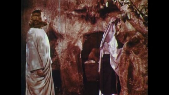 UNITED STATES: 1950s: lady cries by tomb. Jesus stands behind lady ...