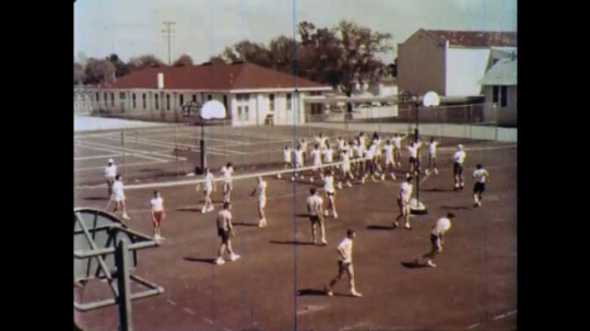 1960s: UNITED STATES: children exercise and stretch before game. People ...
