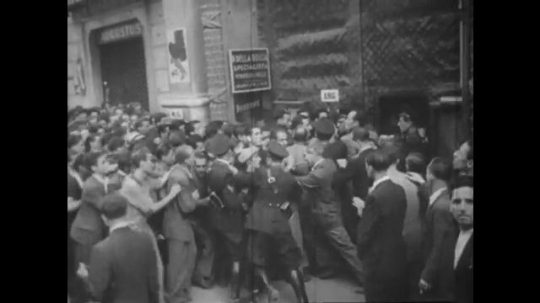 Europe 1940s: crowds push through lines. Angry people. Man fights ...