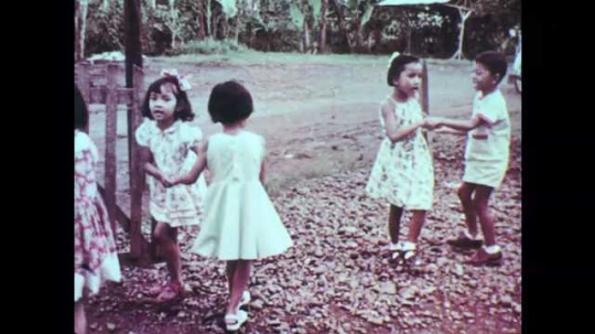 1950s: Woman sings and play acts. Boy play acts. Boy and girl dress up ...