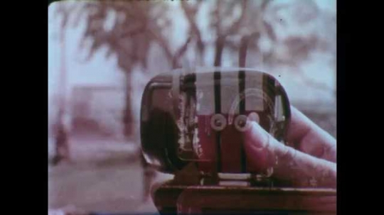 1950s: UNITED STATES: industrial generators. Hand turns crank on small ...