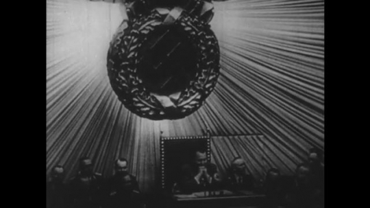1950s: Views of Nazi rally, Adolph Hitler speaking. Hands salute Hitler ...