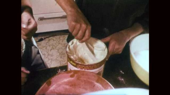 1970s: Hand scoops shortening from can, tilt up to girl. Hands _drop_ ...