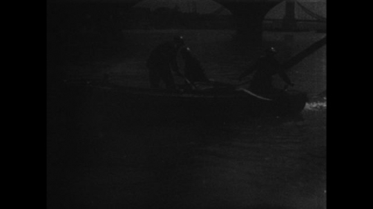 Europe 1940s: Fire brigade on Thames in boat. Fireman take water from ...