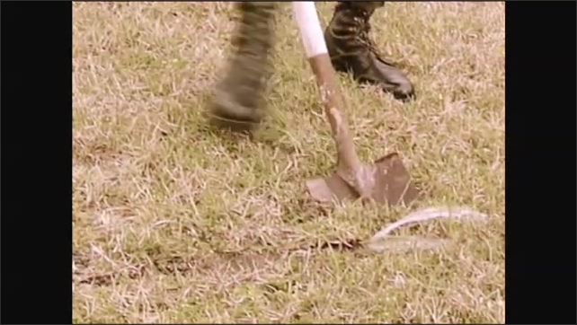 2000s: Water leaking from pipe onto grass. Shovel digging ground next ...