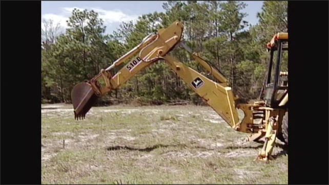 2000s: Front view of excavator digging, bucket lifting. Excavator ...