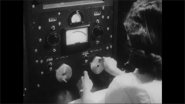 1950s: UNITED STATES: lady works in control room of reactor. Operator ...