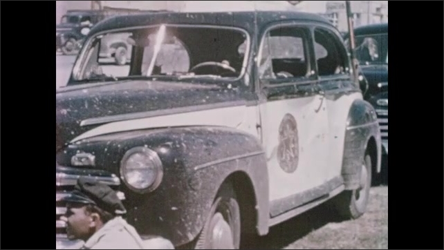 1940s: Bulldozers move wreckage off of road. Police car. Car with hole ...