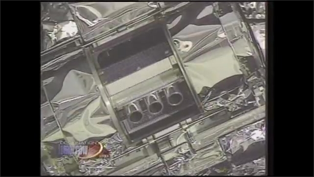 1990s: Man and woman take in laboratory. Exhaust system turns and spins ...