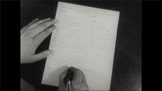 1950s: Person writes on report form for car accident. – Archival Footage