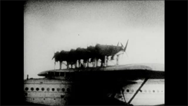 1930s: Train moving through station. Propeller spinning on train ...