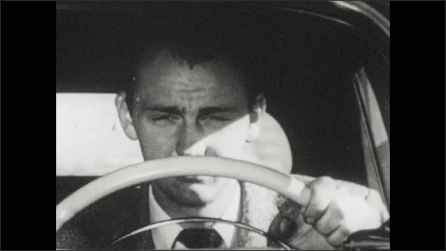 1950s: Drowsy driver closes eyes behind wheel of car. Driver_qt_s ...