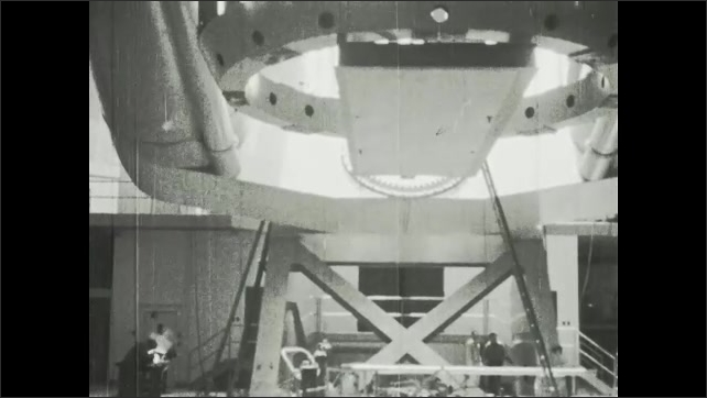 1940s: Workers around the Hale Telescope reflector mirror, standing on ...