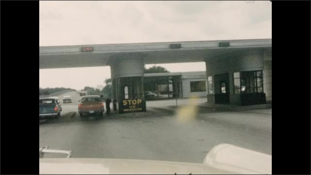 1950s: Tracking shots from car, driving across bridge. Approaching ...