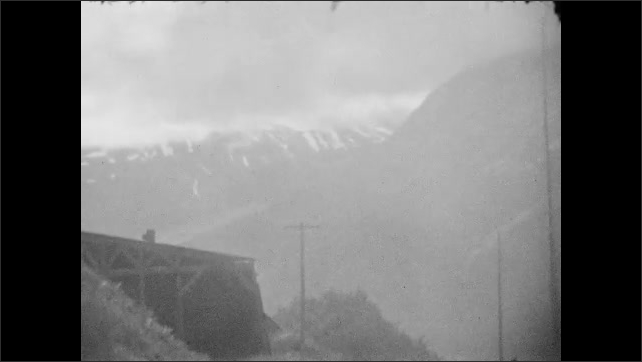 1930s: ALASKA: steam inside railway tunnel. View along railway tracks ...
