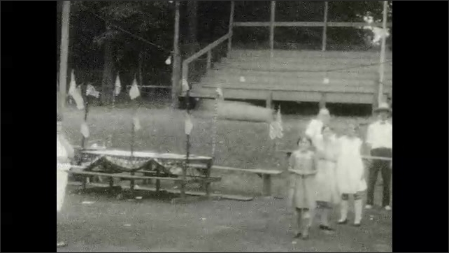 1920s: Sign hangs on tent. Men talk at ticket booth. Circus tents in ...