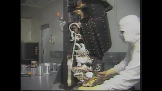 1990s: Scientist moves satellite instrument detector in workshop ...