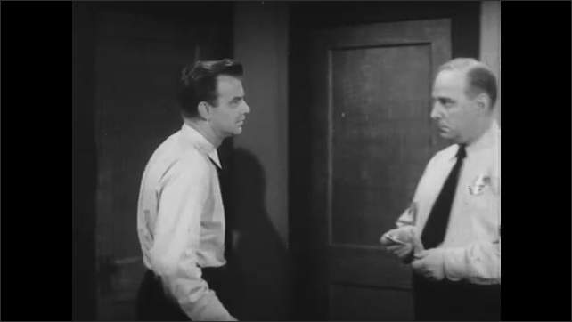 1950s: Police officer and Sergeant talk. – Archival Footage