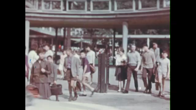 1960s: Students walk through busy school courtyard. Students sit at ...