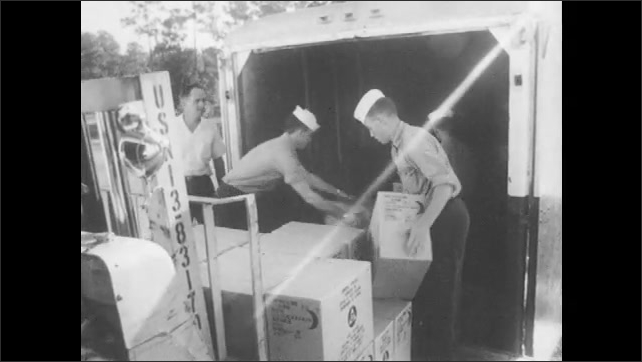 1960s: Sailors load boxes onto truck. – Archival Footage