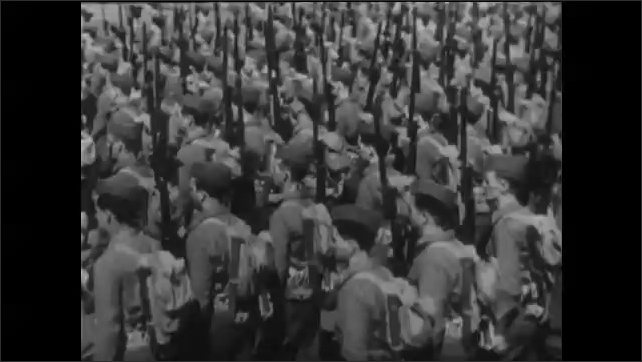 1940s: UNITED STATES: rifles made in factory. Man builds rifle. Machine ...