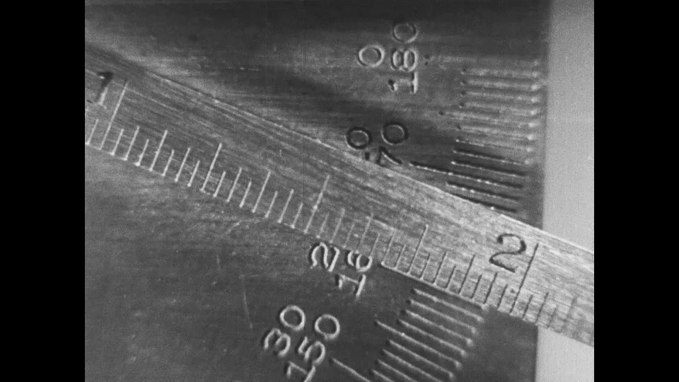 1940s: Angle on protractor. Person points at designs for part. Person ...
