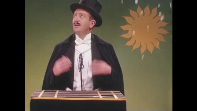 1970s: UNITED STATES: clapper board claps in front of magician on set ...