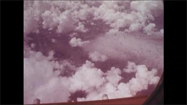 1970s: Pilot in cockpit. Airplane flies. Window. Clouds. – Archival Footage