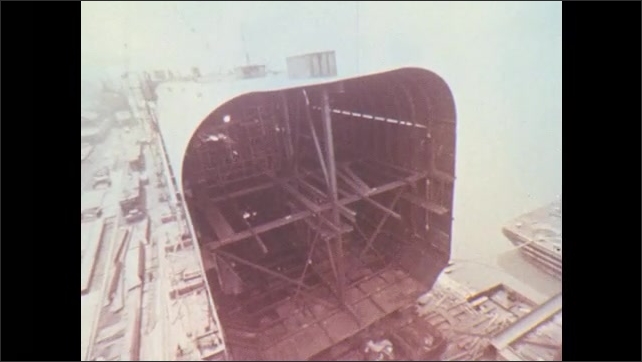 1970s: Construction worker welds steel plate. Massive steel tunnel on ...