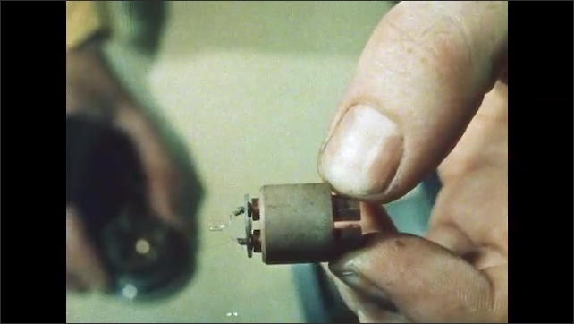 1960s: UNITED STATES: man takes modern electron microscope apart ...