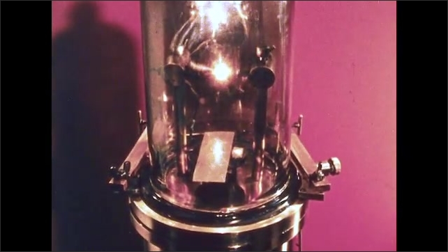 1960s: UNITED STATES: specimen on slide beneath carbon rods. Cast made ...