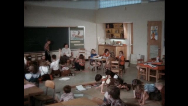 1960s: Students sit at desks, talk. Students work in groups throughout ...