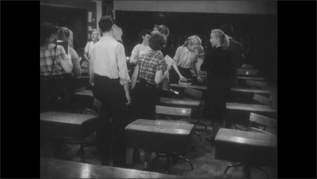 1950s: Students exit classroom. – Archival Footage