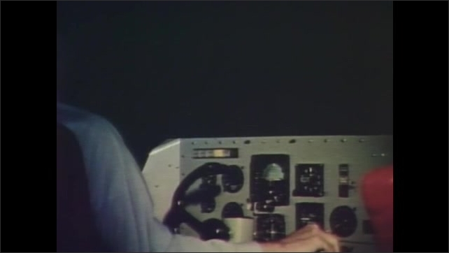 1980s: A pilot in the cockpit of a flight simulator speaks into his ...