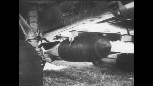 1940s: Soldiers around officer by map. Soldiers pushing bomb to plane ...
