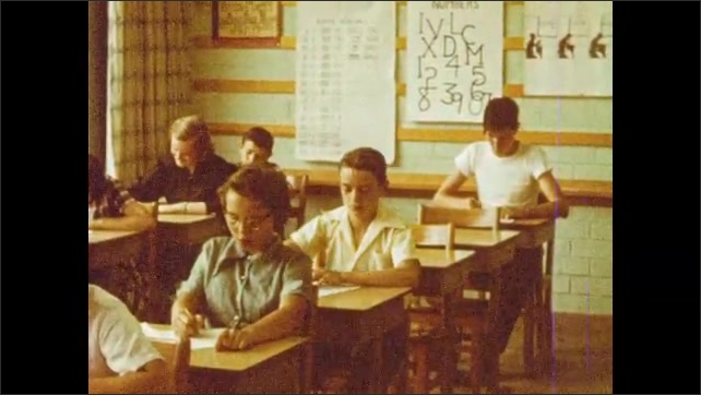 1950s: Boy looks into microscope and writes notes. Classroom. Boy ...