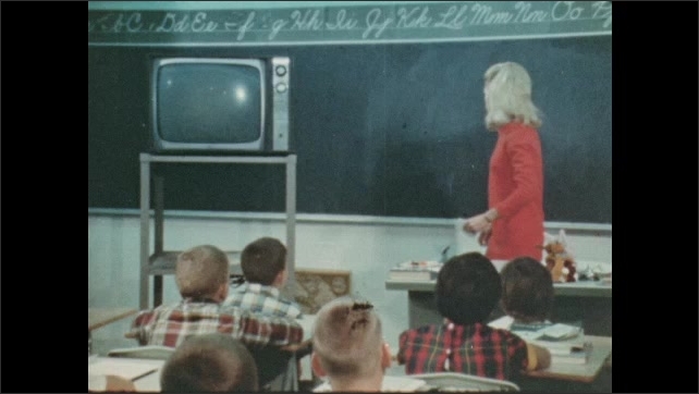 1960s: Teacher conducts lesson in TV studio. Students watch TV. Teacher ...