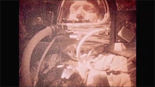 1960s: UNITED STATES: astronaut in space suit in capsule during orbit ...