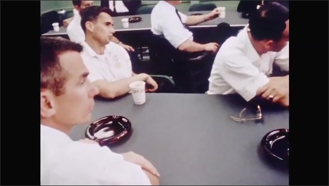 1960s: UNITED STATES: Spacecraft Checkout Facility. Men enter building ...